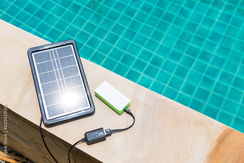 Portable solar cell panel with space on pool water background, clean ...