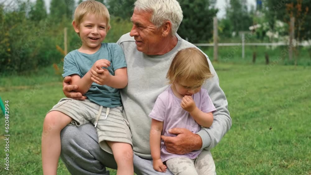 Grandfather and grandchildren have fun during walk In Park. Happy ...