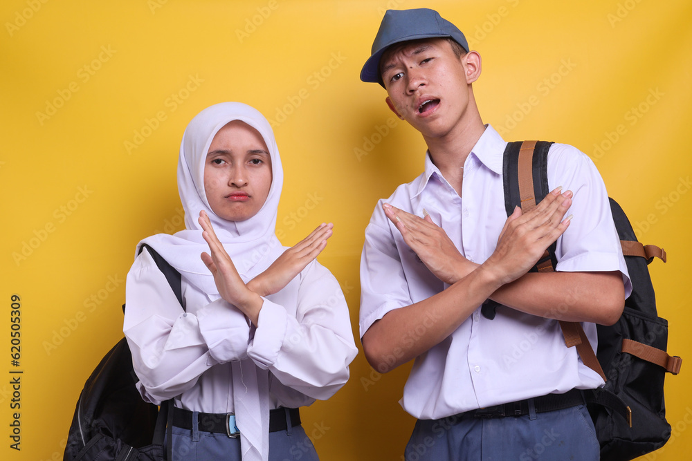 Two Indonesian high school students in white and grey uniform showing ...