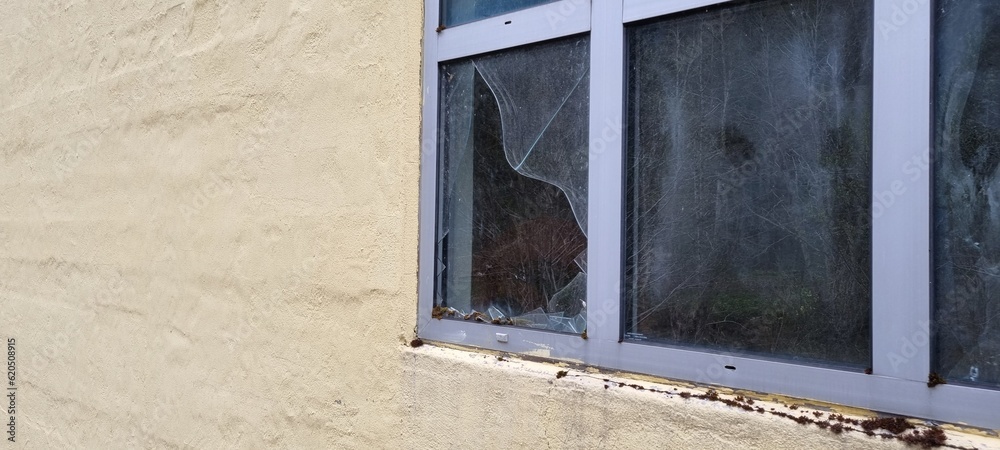 Broken window on old abandoned building in the forest, glass shards and ...