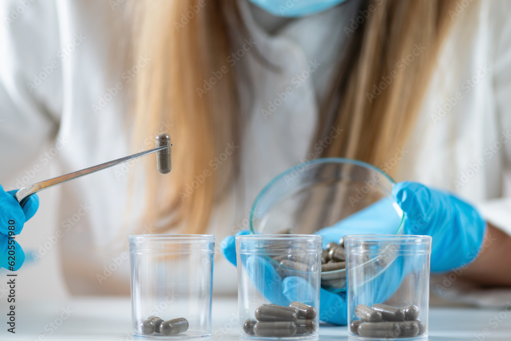 Scientist carefully prepares fecal transplant caps in the lab ...