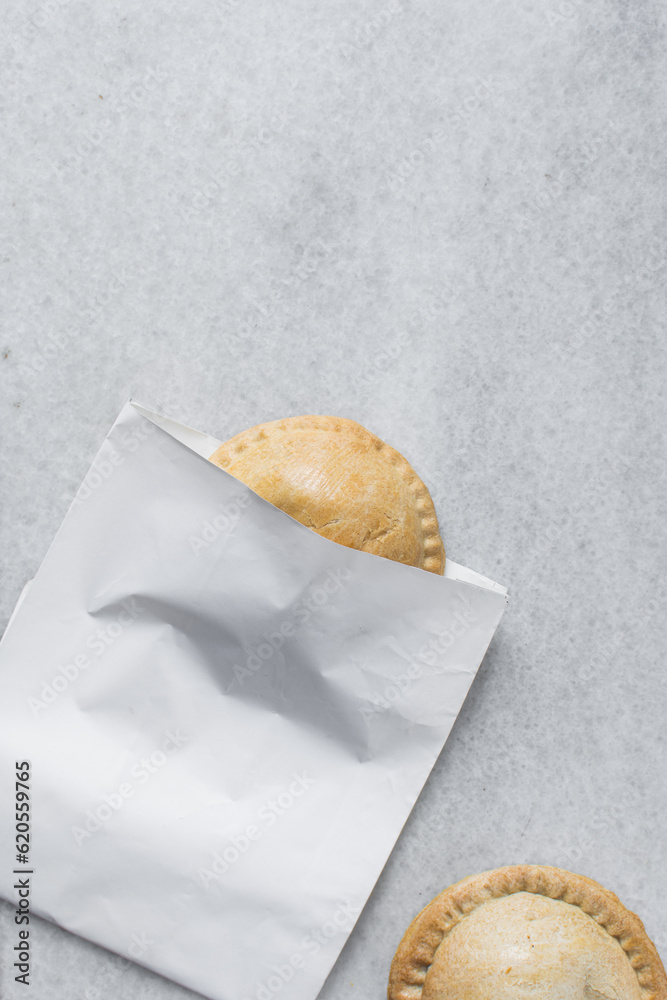 Nigerian meat pie in white bakery bag, freshly baked nigerian meat pie ...