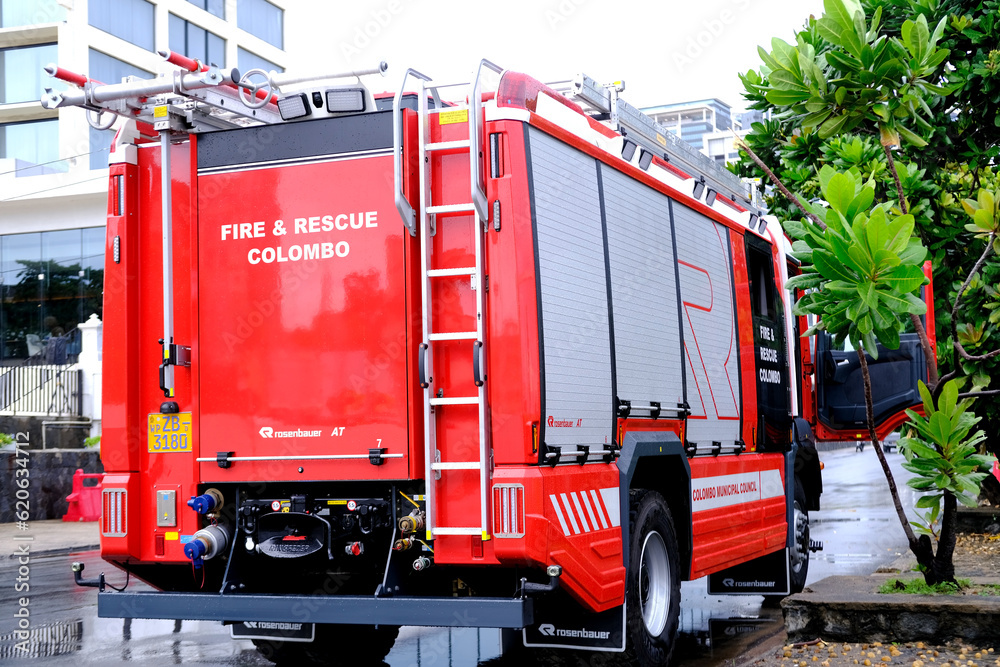 fire department's big red fire truck, emergency van on city street ...