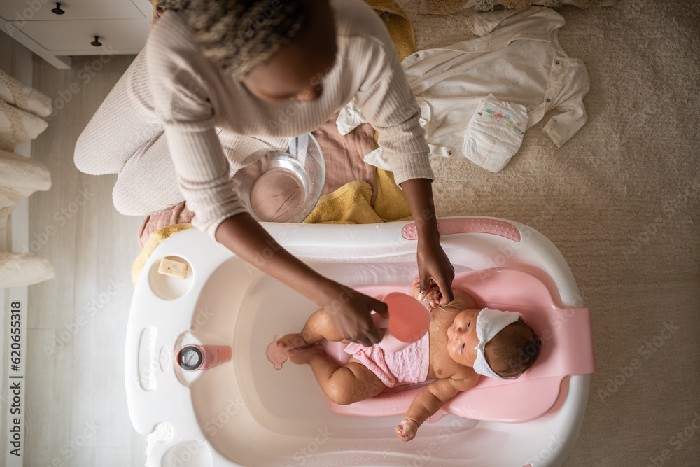 Baby girl having bath time in bedroom Stock Photo | Adobe Stock