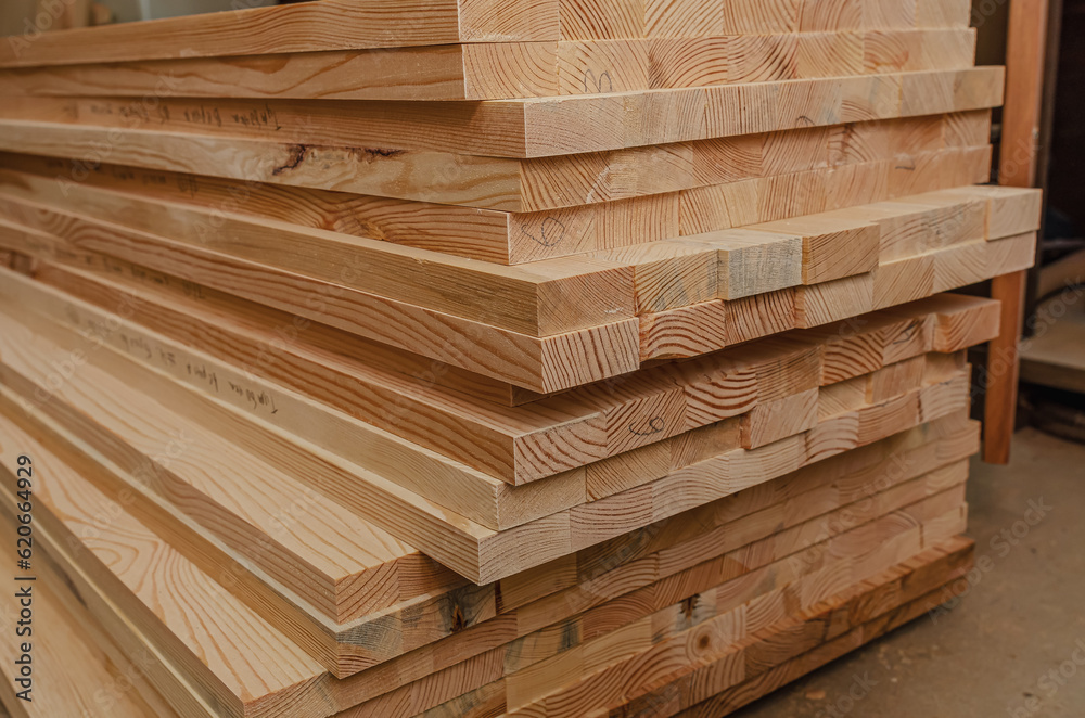 Sawn wooden boards stacked in a production workshop. Carpenter. Stock ...