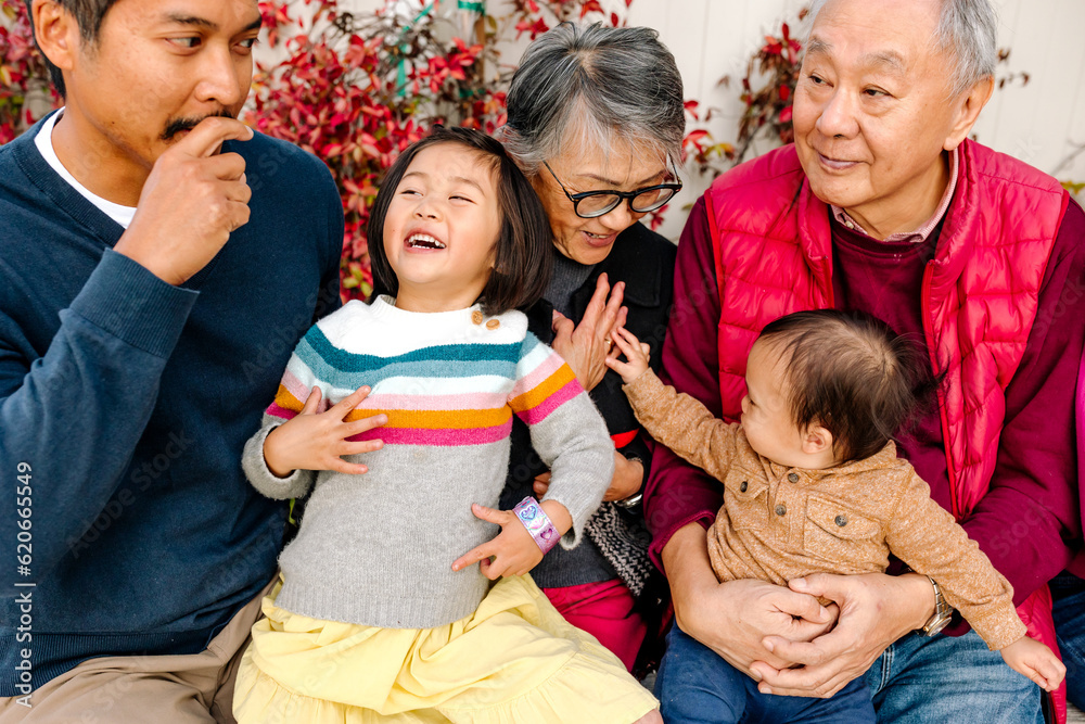 Happy asian family sitting together outdoors with grandparents Stock ...