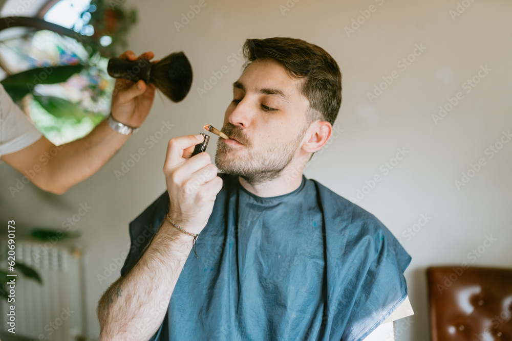 Man smoking a joint while getting a haircut Stock Photo | Adobe Stock