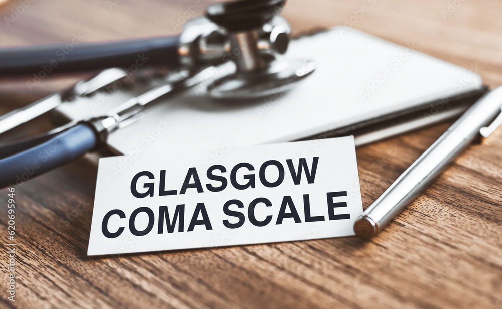 Glasgow Coma Scale - text on white sheet on a wooden background with a ...