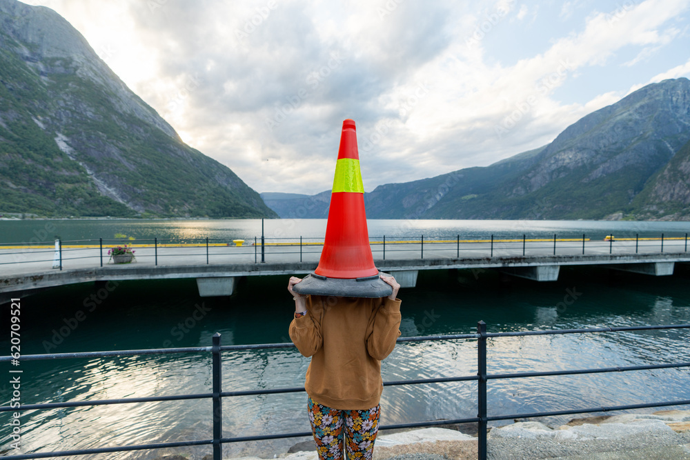 Woman with traffic cone on her head Stock Photo | Adobe Stock