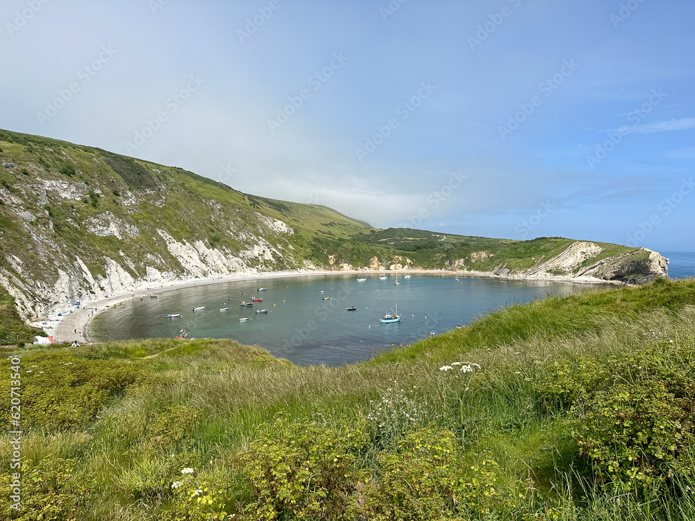 Lulworth Cove and beach view. Lulworth Cove bay, beach and cliffs view ...