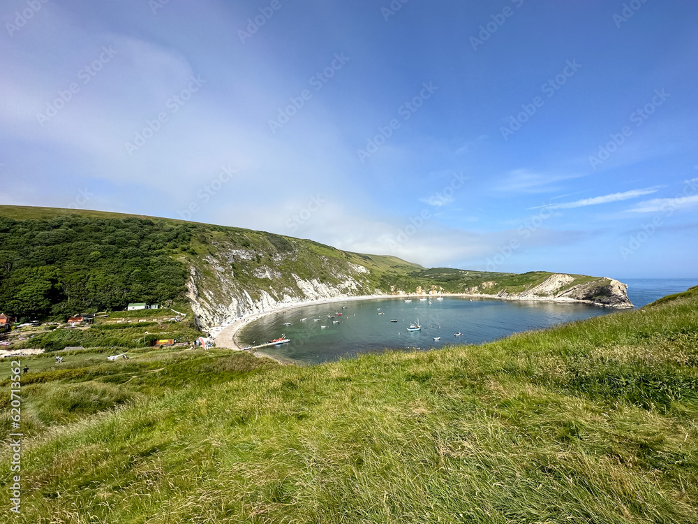 Lulworth Cove and beach view. Lulworth Cove bay, beach and cliffs view ...