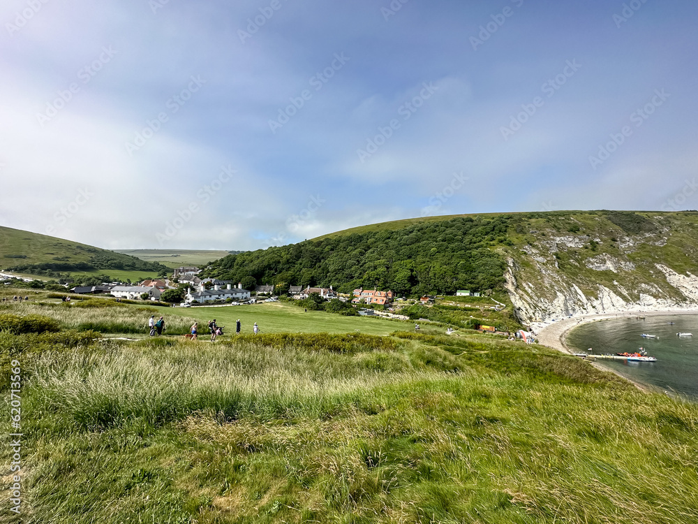 Lulworth Cove and beach view. Lulworth Cove bay, beach and cliffs view ...