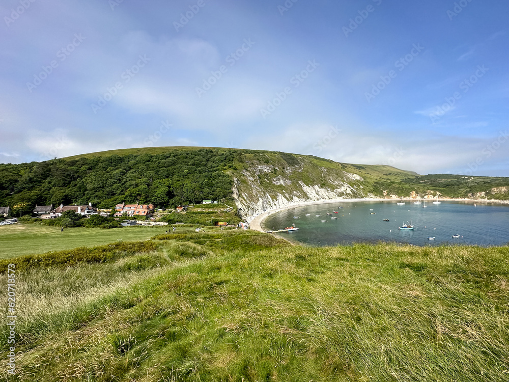 Lulworth Cove and beach view. Lulworth Cove bay, beach and cliffs view ...