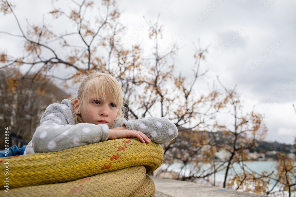 Sad child in the port Stock Photo | Adobe Stock