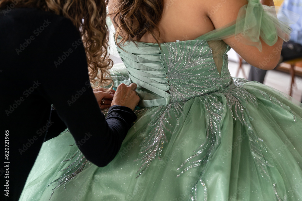 Girl Getting Gown Laced up for Quinceanera Stock Photo | Adobe Stock