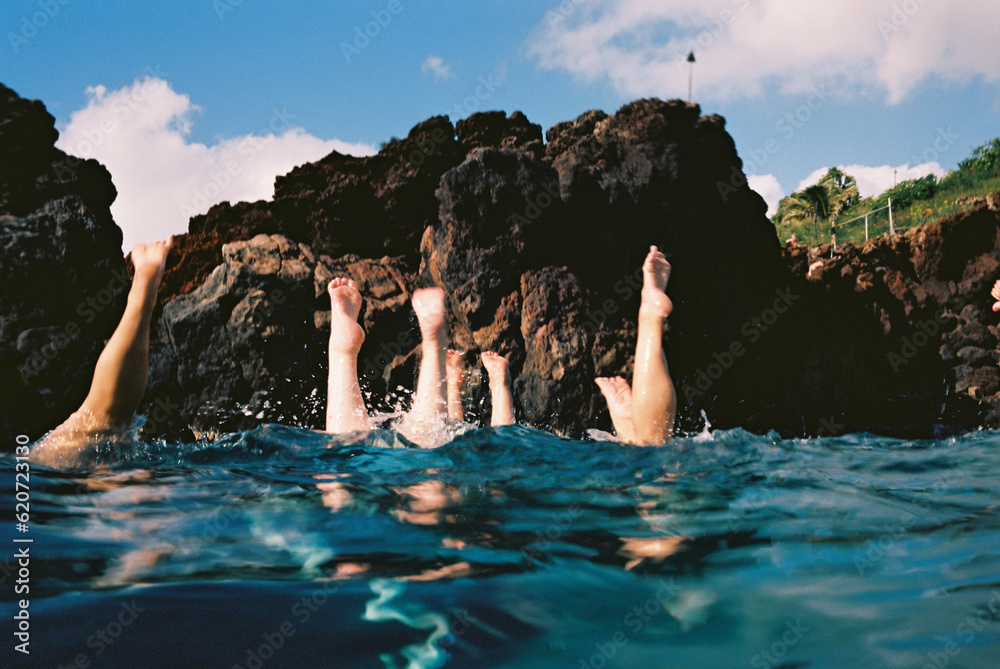 diving feet above ocean with rock in hawaii Stock Photo | Adobe Stock