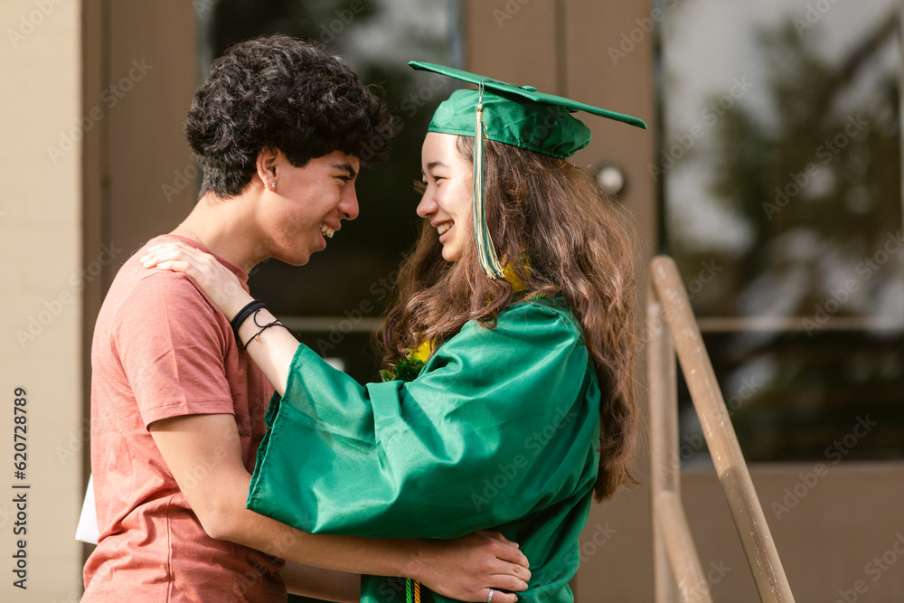 Teens hugging happy, graduation day Stock Photo | Adobe Stock