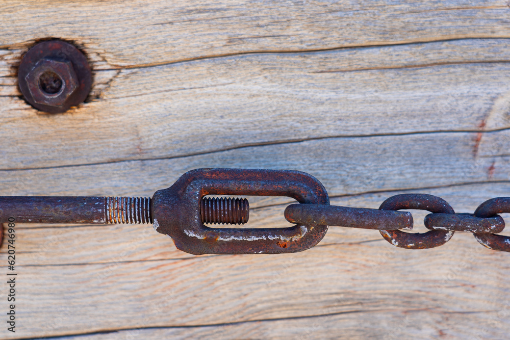 Old rusty bolt locked tight pulling on heavy duty iron chain links. See ...