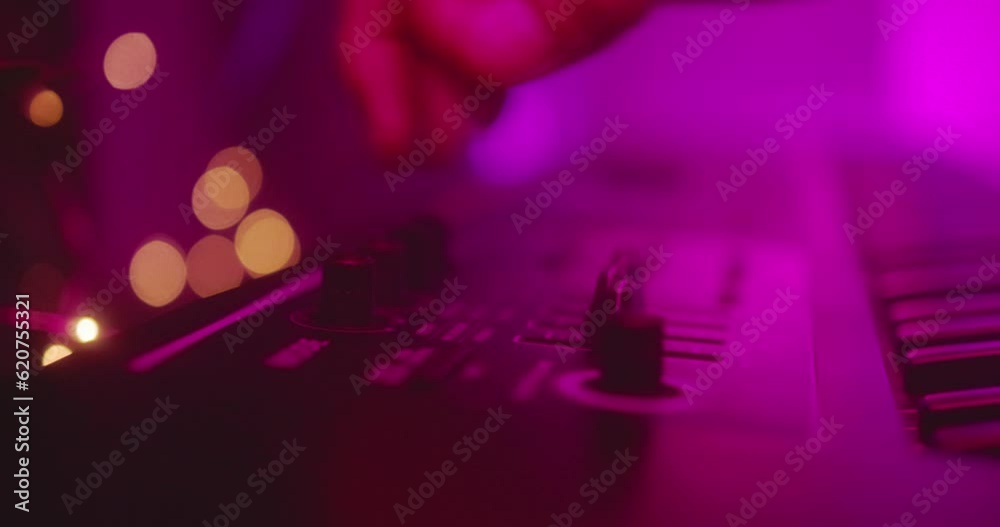 Shakey close up of hands of producer, musician turning sliders and ...