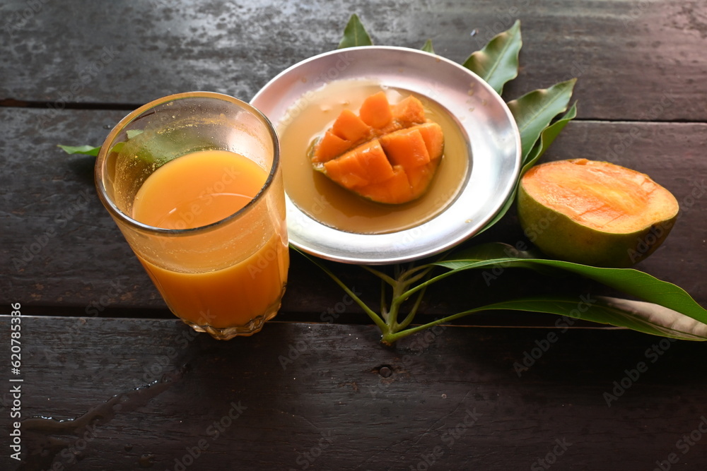 Mango juice with mango slice isolated on black background. Mango shake ...