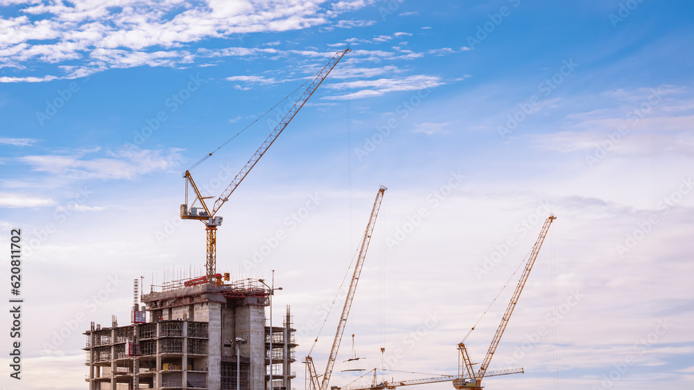 Tower cranes are working on top of high building structure against ...