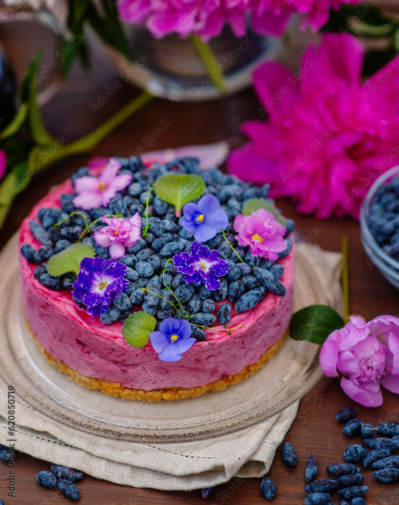 Purple cheesecake with honeysuckle, violet flowers and a background of ...