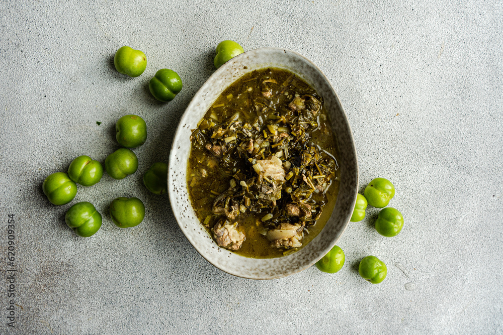 Overhead view of a bowl of traditional Georgian lamb and green plum ...