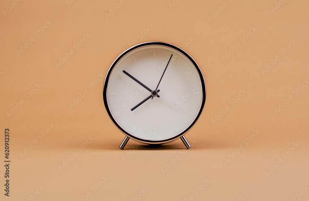 Alarm clock. Beautiful modern clock lies on paper background. time ...