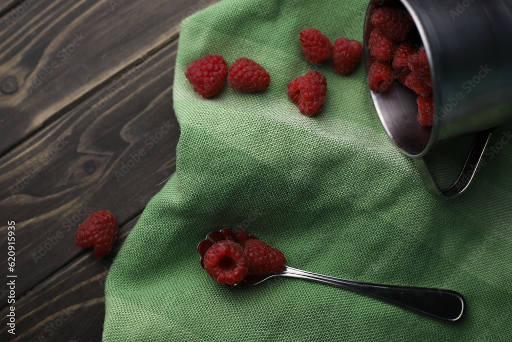 fresh summer sweet healthy red color raspberries in a tin mug on a ...