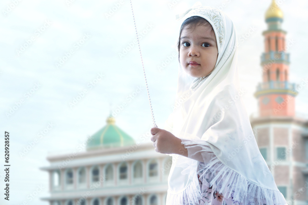 Cute little Muslim girl standing in front of the Mosque, blurred Mosque ...