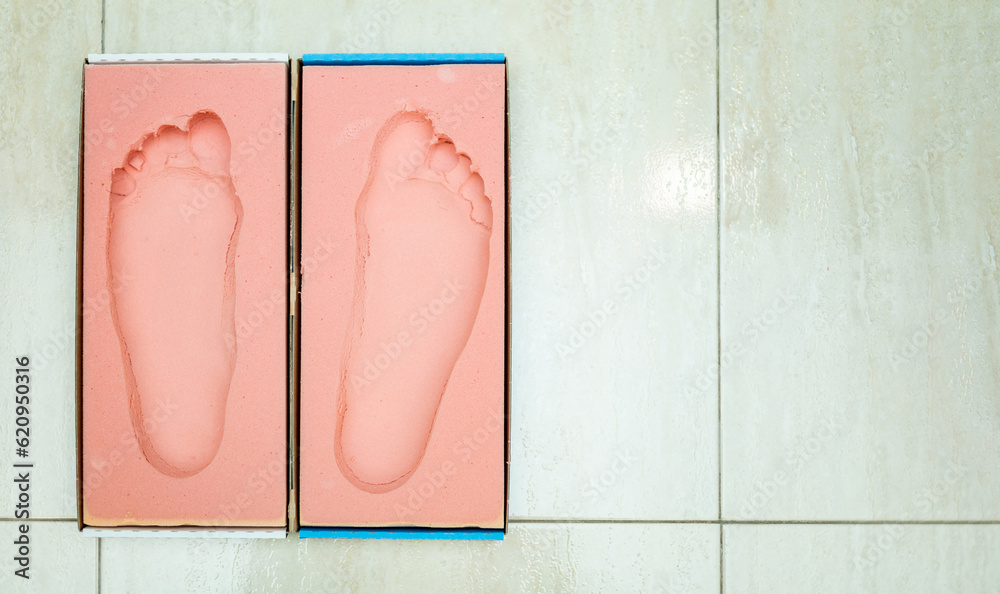 A photo of a pink phenolic foam for printing the footprint. Concept of ...