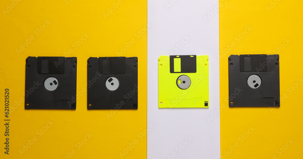 Outdated technologies. Retro floppy disk on a yellow-white background ...