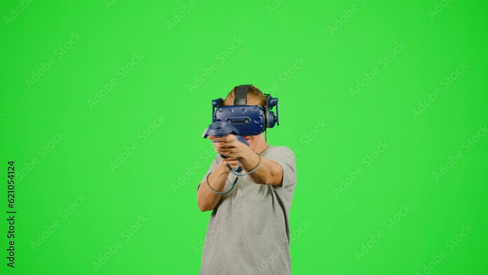 The woman shooting in virtual reality on chroma key green screen ...