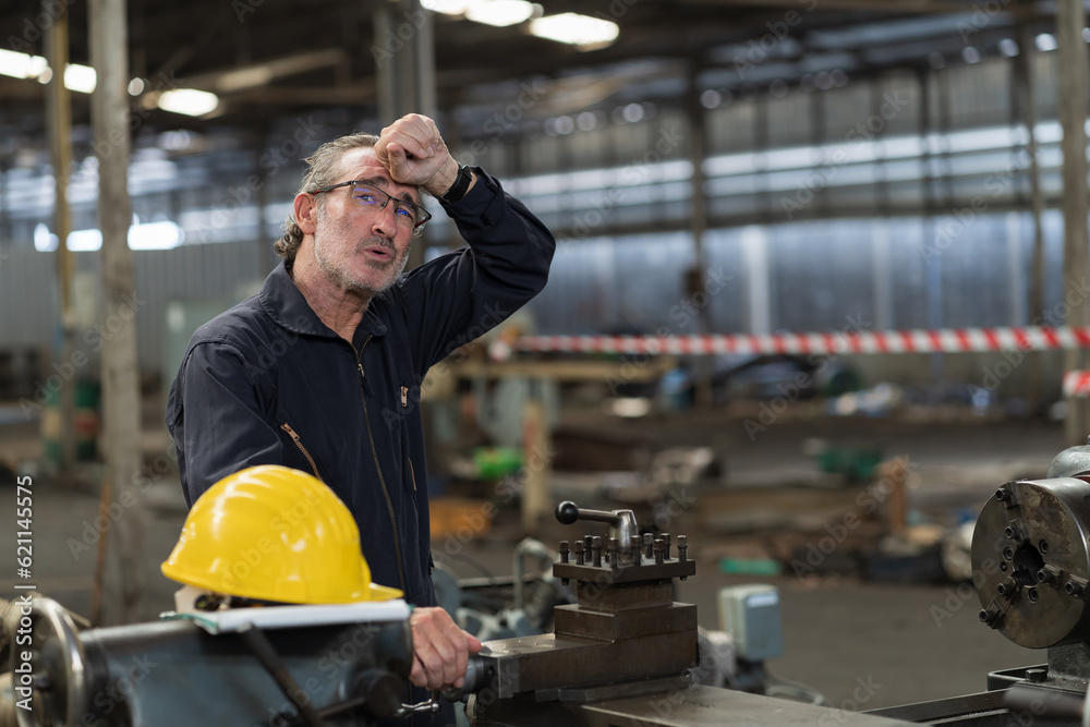 Senior male engineer worker working in factory in break time. Mature ...