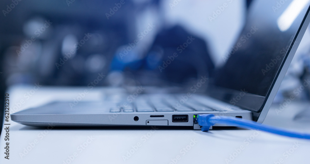 close up on computer port interface with blue line lan cable connected ...