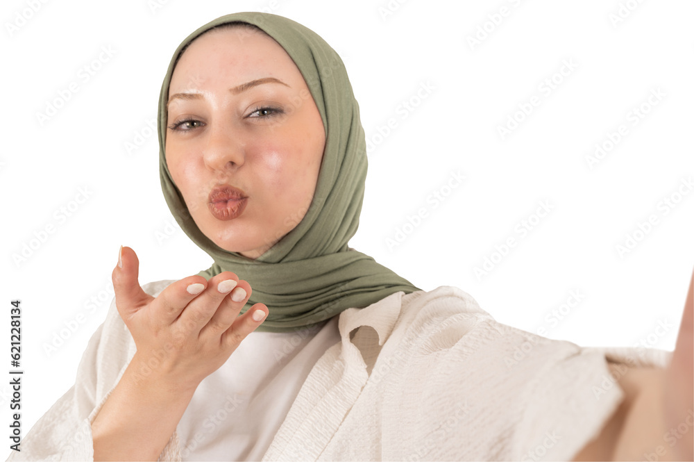 Blowing air kiss, close up young caucasian muslim woman blowing air ...