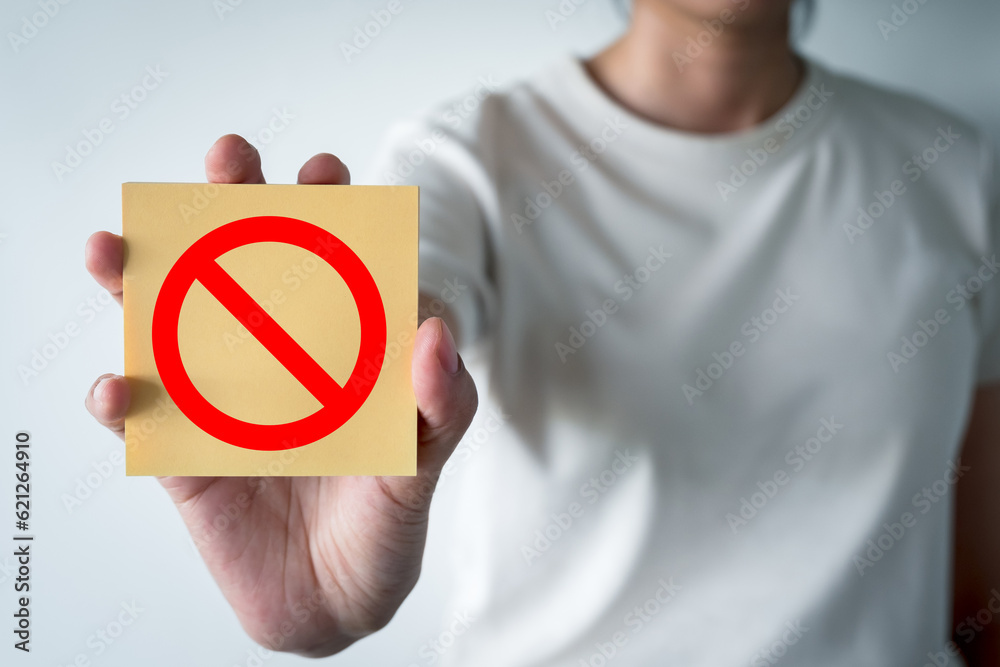 Woman holding yellow sticky note with red prohibition sign perfect for ...