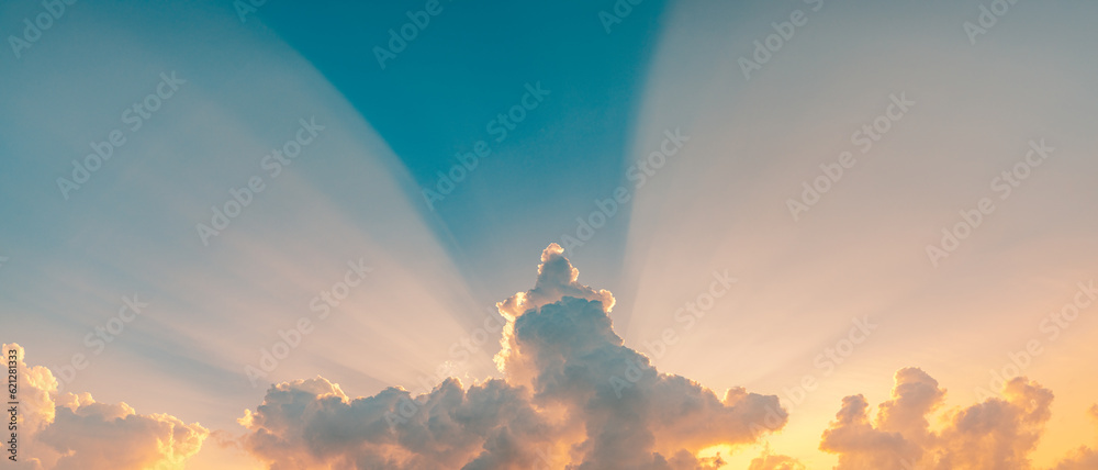Beautiful colorful sunset sky above clouds with dramatic light, beams ...