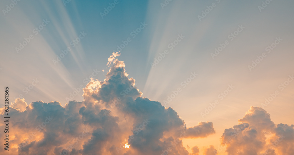 Beautiful colorful sunset sky above clouds with dramatic light, beams ...