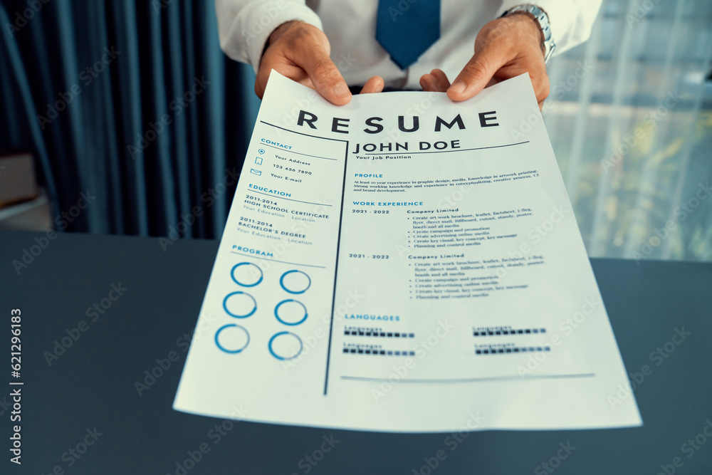 Confident man wearing suit in formal office, hand holding resume paper ...