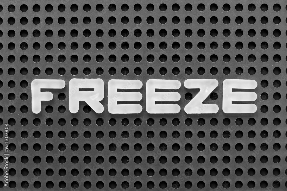 White alphabet letter in word freeze on black pegboard background Stock ...