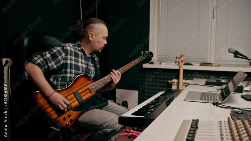 rock performer with electric guitar in recording studio recording ...