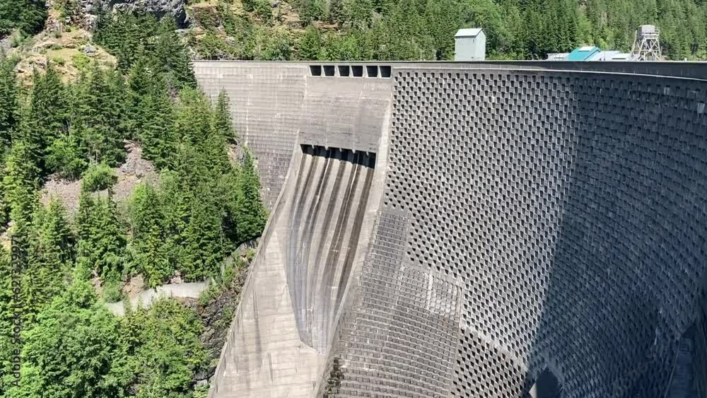 Tilt up view to show the scale of the massive Ross Dam at Ross Lake ...