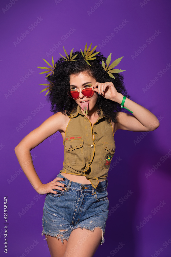 Beautiful rastafarian woman in red sunglasses with marijuana leaves in ...