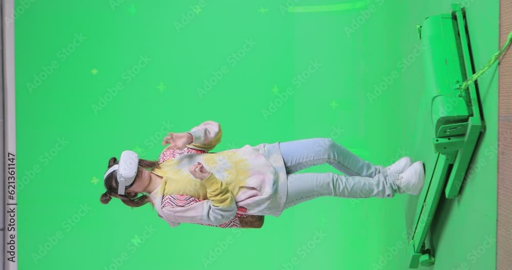 Vertical shot on green screen background. VR or AR online walk. Girl ...