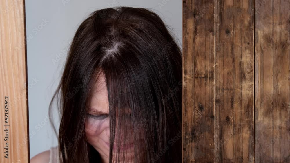 close-up of female tear-stained face, beaten woman with bruises and ...