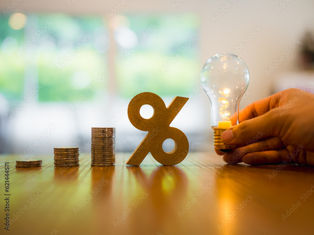 Percentage model and coins stack with light bulb . Idea and management ...