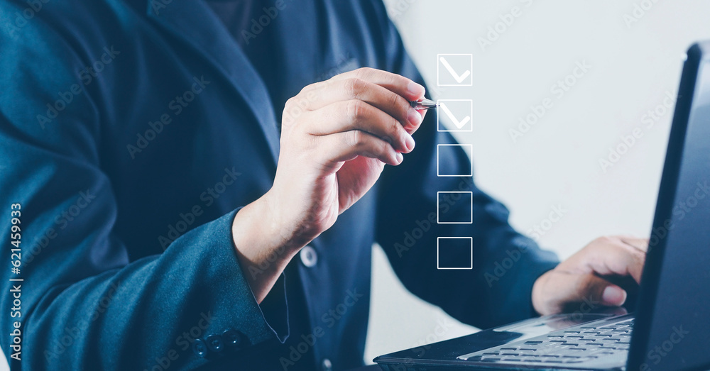Businessman use pen to tick correct sign mark in checkbox for quality ...