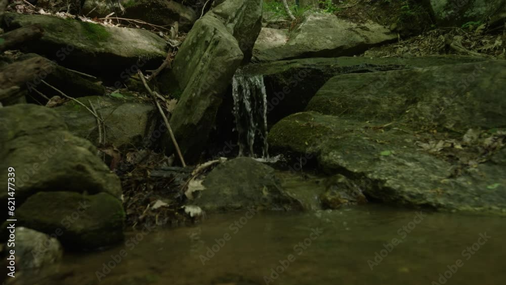 Close up slow motion of water flowing over rocks in creek in Pisgah ...