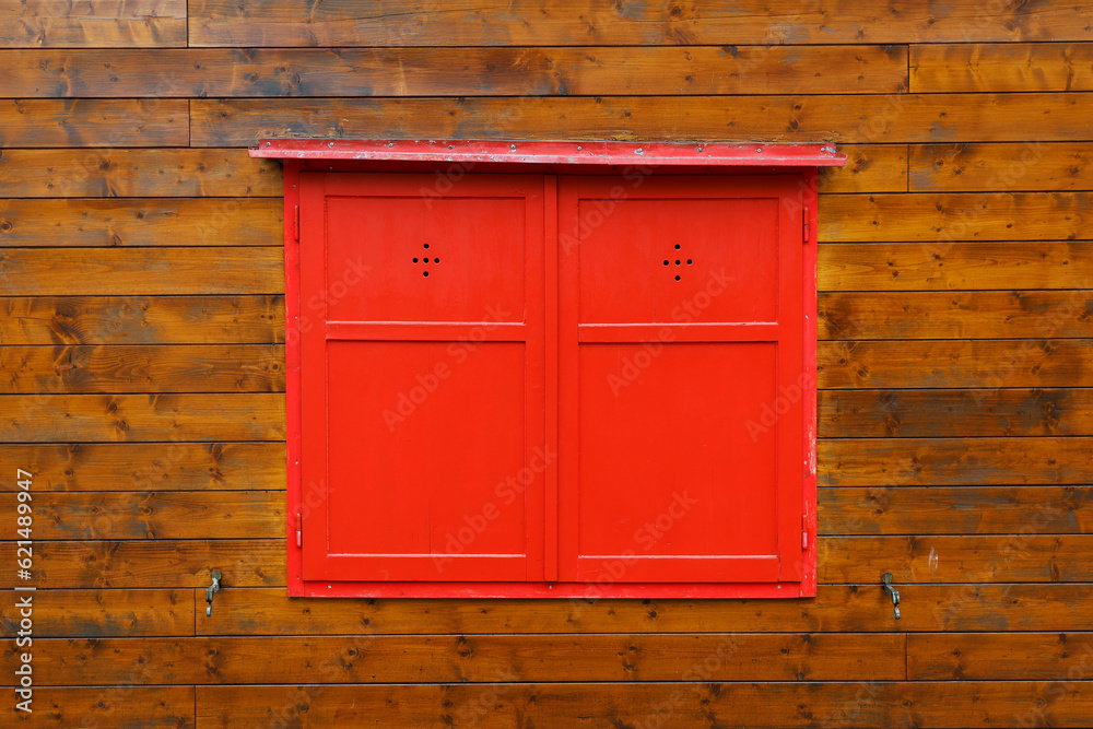 Small window of a wooden house in a small town in Austria. Retro style ...